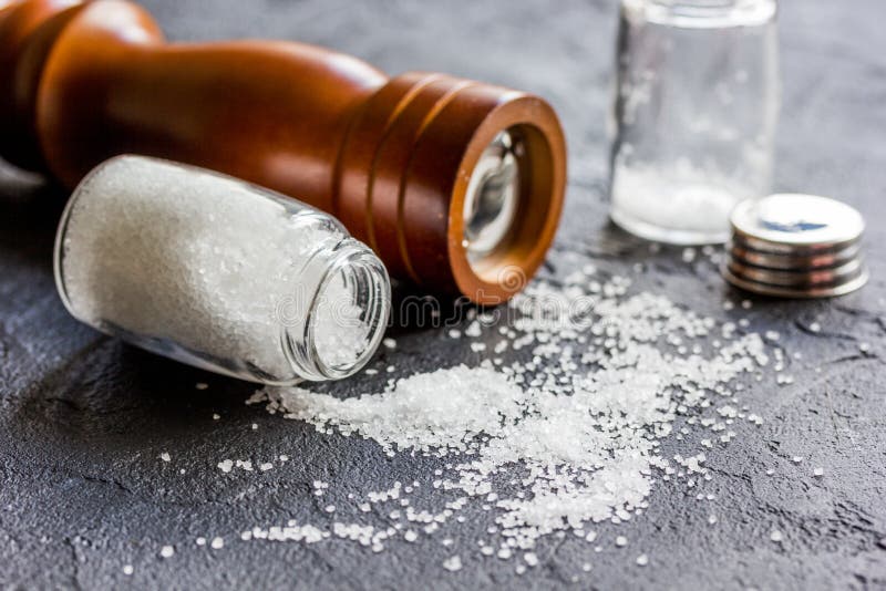 Salt in Glass Bottle Scattered on Dark Table Background Stock Photo ...