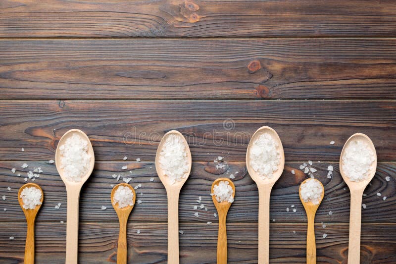 Salt on Many Wooden Spoon on Wood Background. Spoons with Different ...