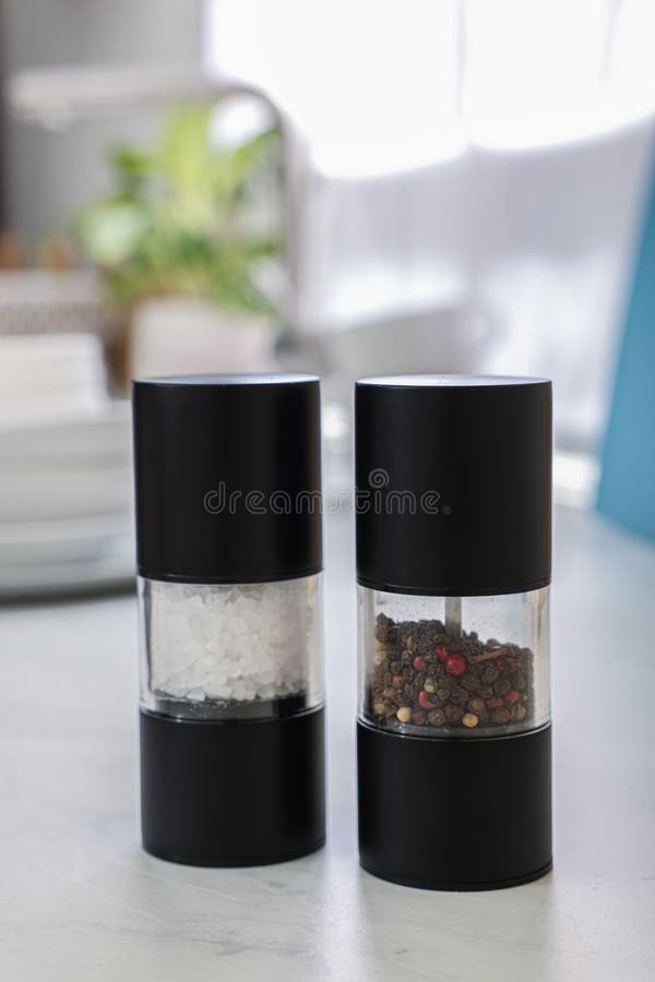 Salt and Pepper Shakers on White Table Stock Photo - Image of material ...