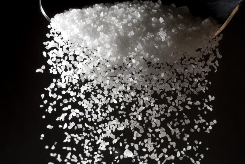 Salt pouring from spoon stock photo. Image of mineral - 52394138
