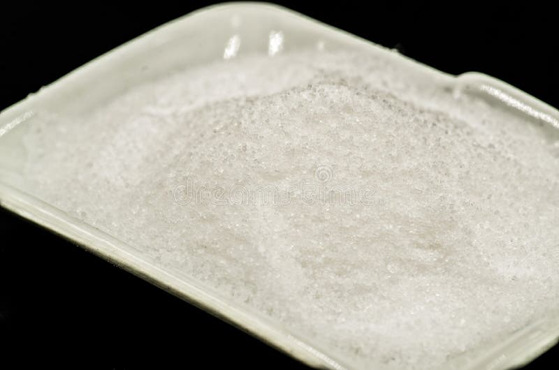 Salt in a Rectangular Plate on Black with a Spoon Stock Image - Image ...