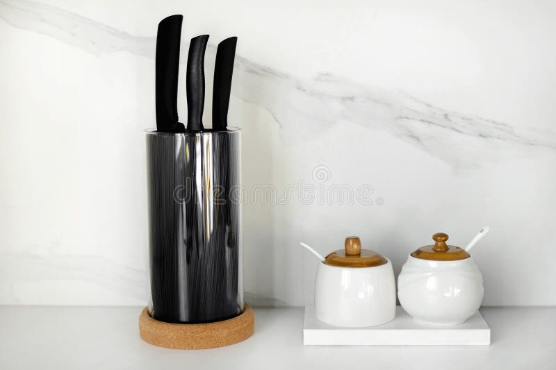 A Salt Shaker and a Sugar Bowl in White with Wooden Lids Stand on a ...