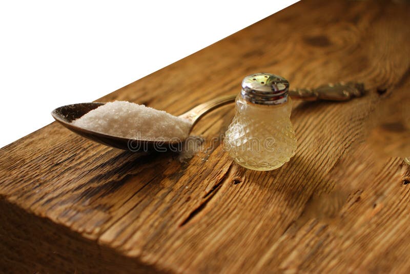 Salt in a Spoon on a Table with a Container for Salt Close-up Stock ...