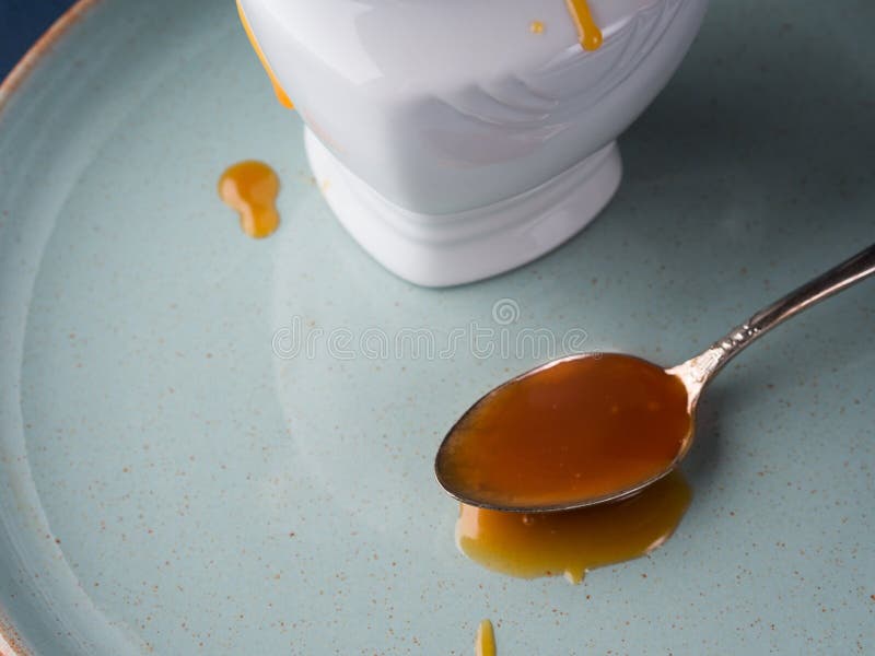 Salted caramel in a spoon stock photo. Image of background - 111021366