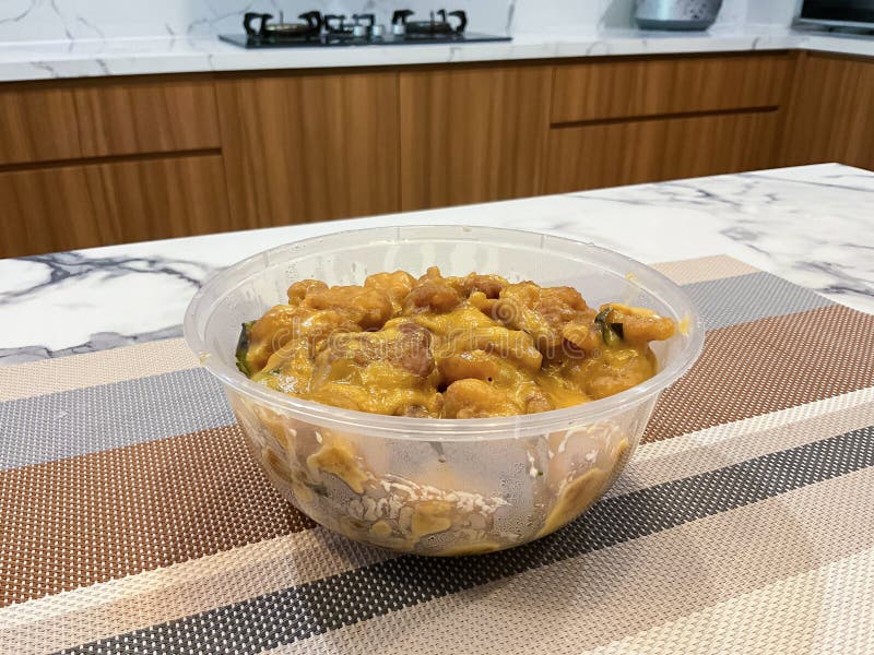 Salted Egg Chicken Inside a Plastic Bowl on a Kitchen Counter Stock ...