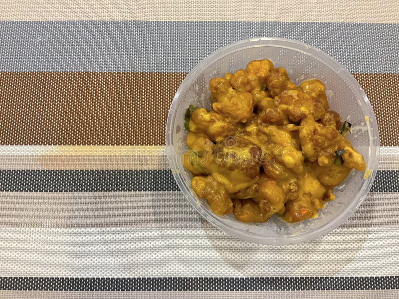 Salted Egg Chicken Inside a Plastic Bowl on a Kitchen Counter Stock ...