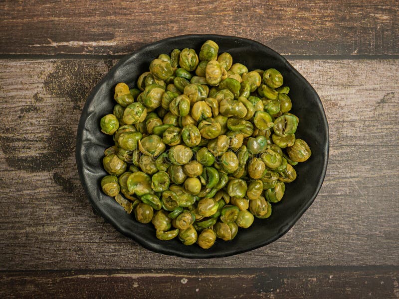 Salted Green Peas in Black Bowl on Wood Table Stock Photo - Image of ...