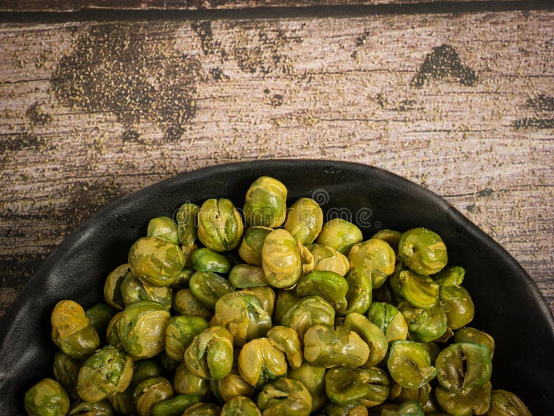 Salted Green Peas in Black Bowl on Wood Table Stock Photo - Image of ...