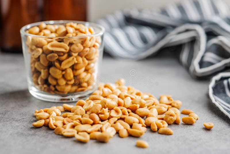 Salted Roasted Peanuts in Glass Cup on Kitchen Table Stock Image ...