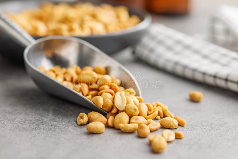 Salted Roasted Peanuts in Scoop on Kitchen Table Stock Photo - Image of ...