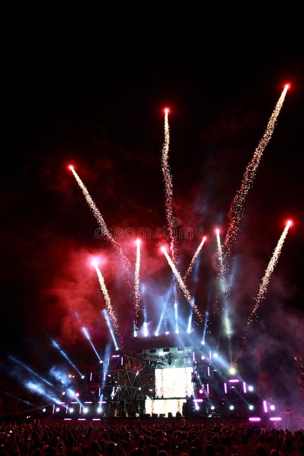 Salute and Fireworks on a Music Stage with Spotlights at Night ...
