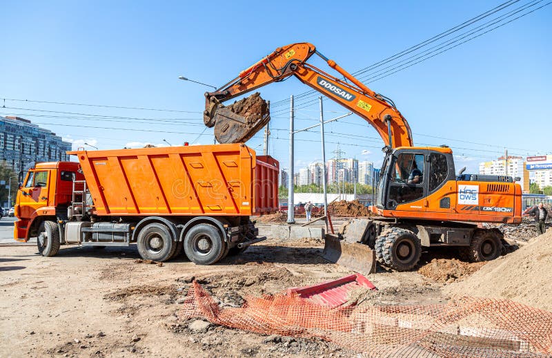 Excavator and Dump Truck are Working on a Construction Site Editorial ...