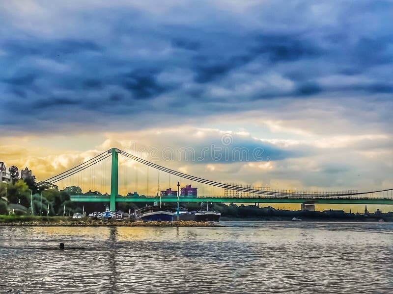 Riverside with Blue Water and Bridge and Sunlight Stock Image - Image ...