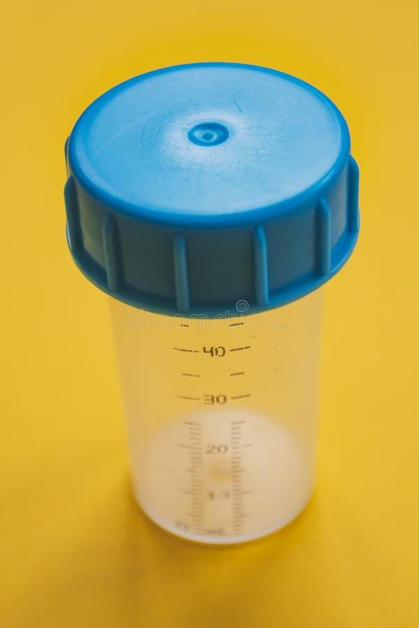 Sample Container for Medical Tests with Blue Cap on a Yellow Background ...