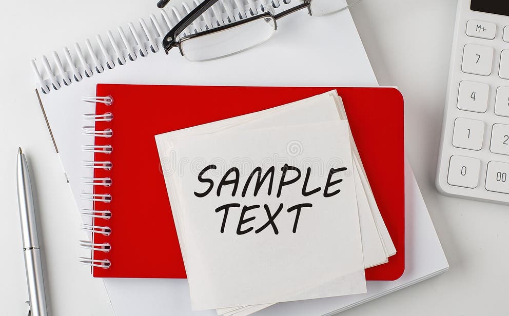 SAMPLE TEXT Word on Sticker on Notepad with Pen and Calculator Stock ...
