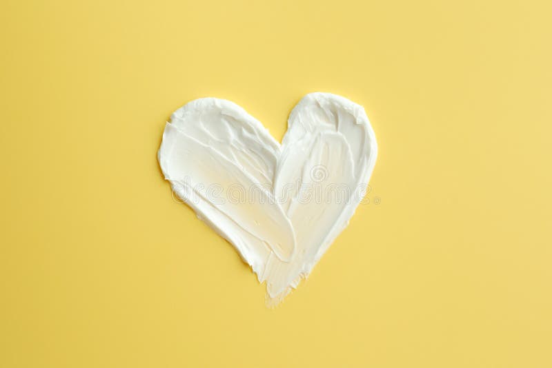 Samples of Face Cream in Shape of Heart on Yellow Background, Top View ...