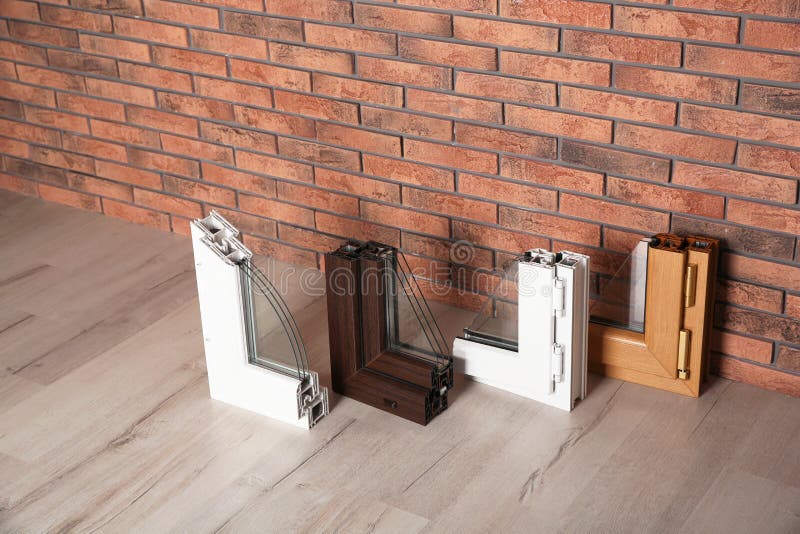 Samples of Modern Window Profiles on Floor Against Brick Wall. Stock ...