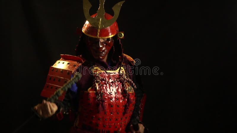 Samurai in Armor and Mask Takes Out a Katana from the Scabbard Stock ...