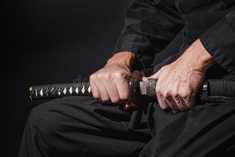 The Samurai Holding a Japanese Katana Sword. Photo of a Warrior Dressed ...