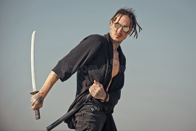 Warrior with Dreadlocks and Open Clothes Showing Tattooed Torso Stock ...