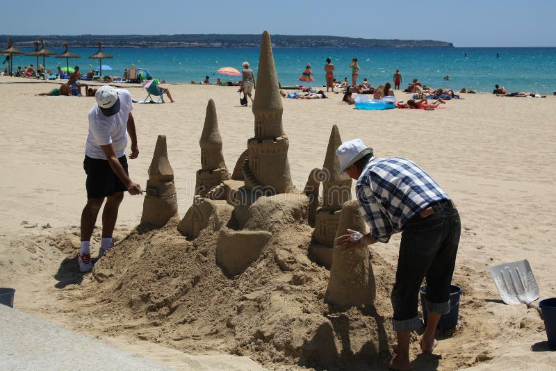Two Men Build a Sand Castle on the Beach on a Sunny Day Editorial Stock ...