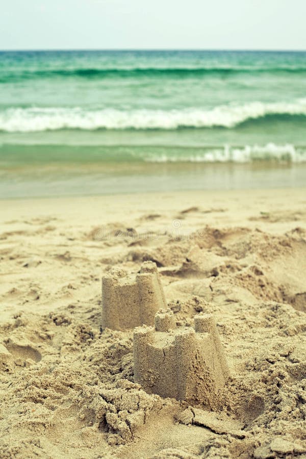 Sand castle on the beach stock photo. Image of green - 180673094