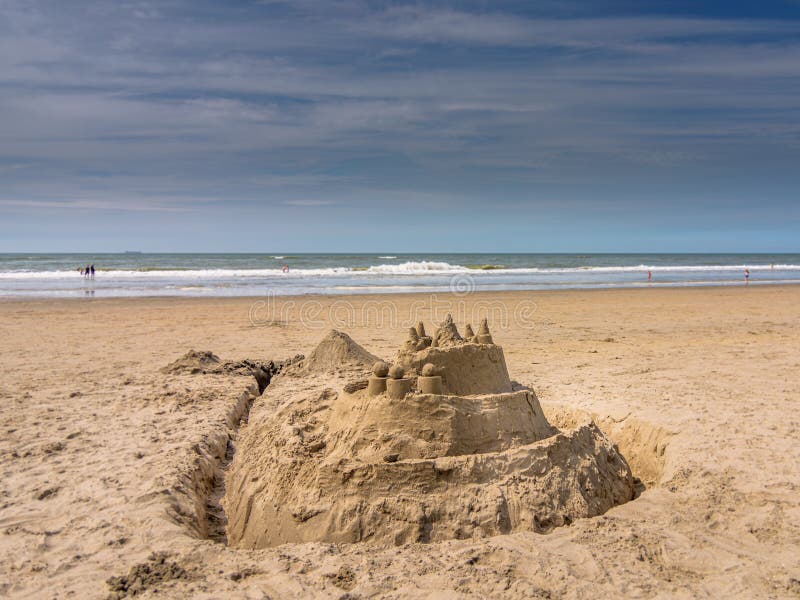 Sand castle on the beach stock image. Image of moat - 305095329