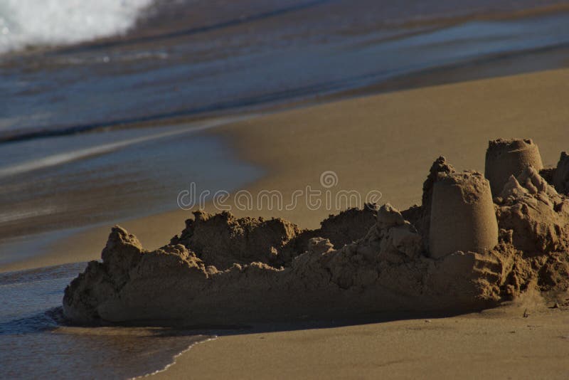 Sand Castle, Blurred with Water, Built Next To the Sea Waves Stock ...