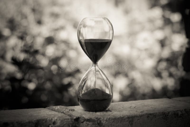 Sand clock in the garden stock photo. Image of flowing - 123769596