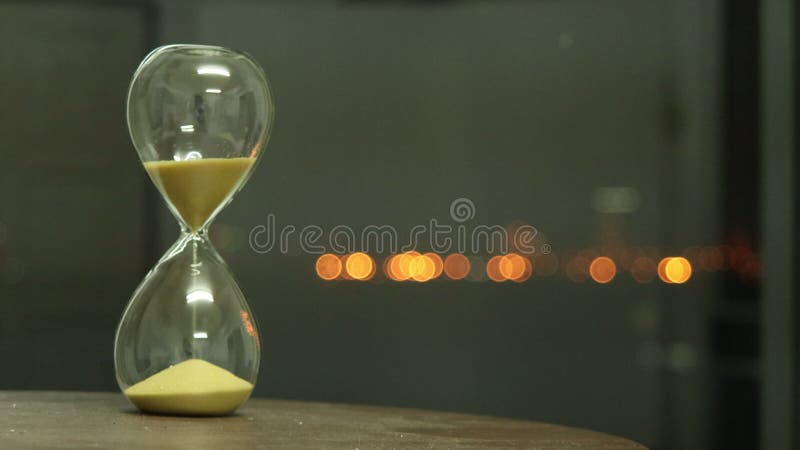 Sand Clock Measuring Time with City Night Light Bokeh Blurred ...