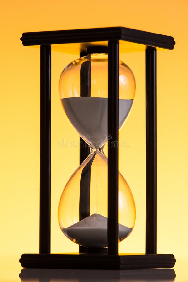 Sand Clock on Yellow Background Stock Image - Image of sand, flowing ...