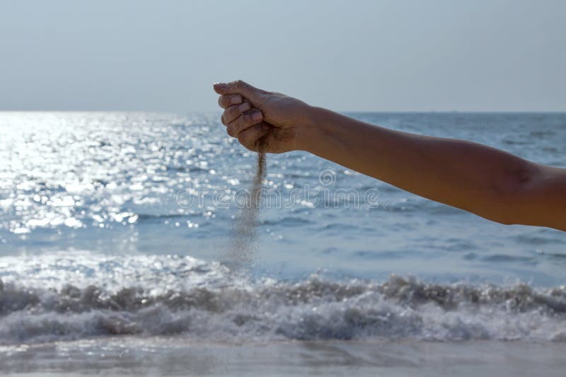 Sand falling from a hand stock image. Image of travel - 86366779