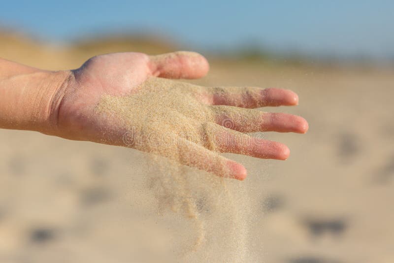 Sand falling from palm stock photo. Image of sputter - 74130624