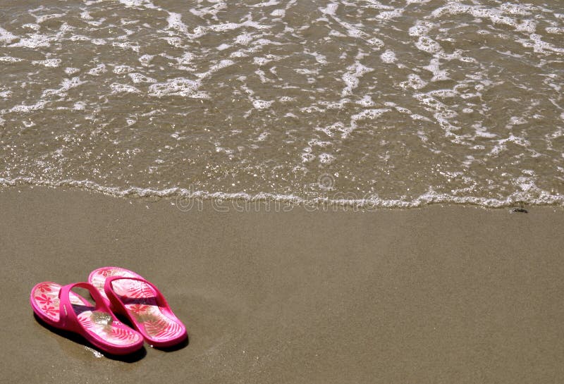 In the Sand - Flip Flops stock photo. Image of background - 33106432