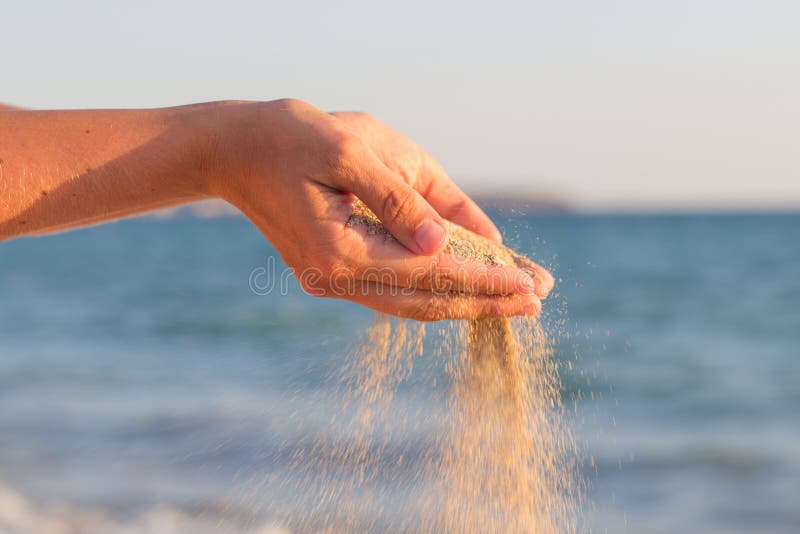 Sand flowing through hands stock photo. Image of wellness - 33521138