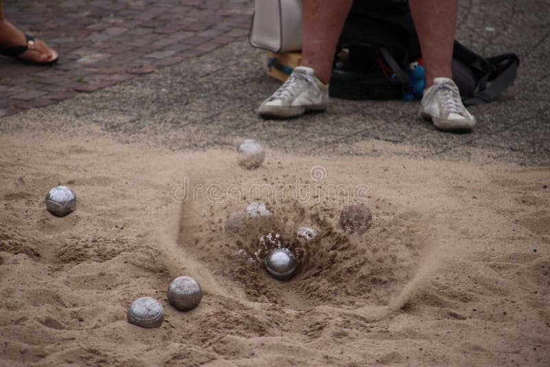 Sand is Flying Away when Ball is Landing on the Ground during Boules ...