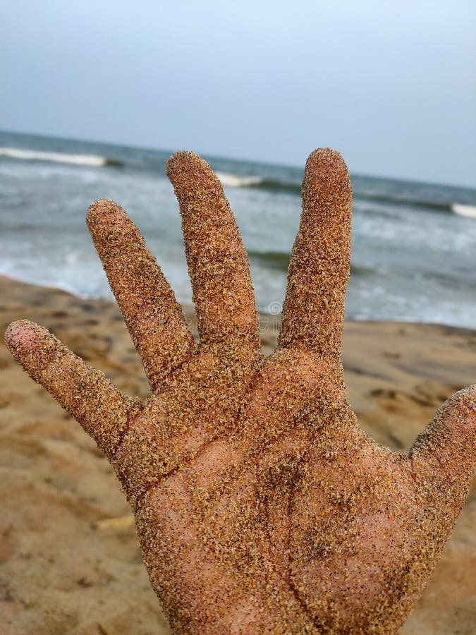 Sand in hand. stock image. Image of mobilephotography - 185959813