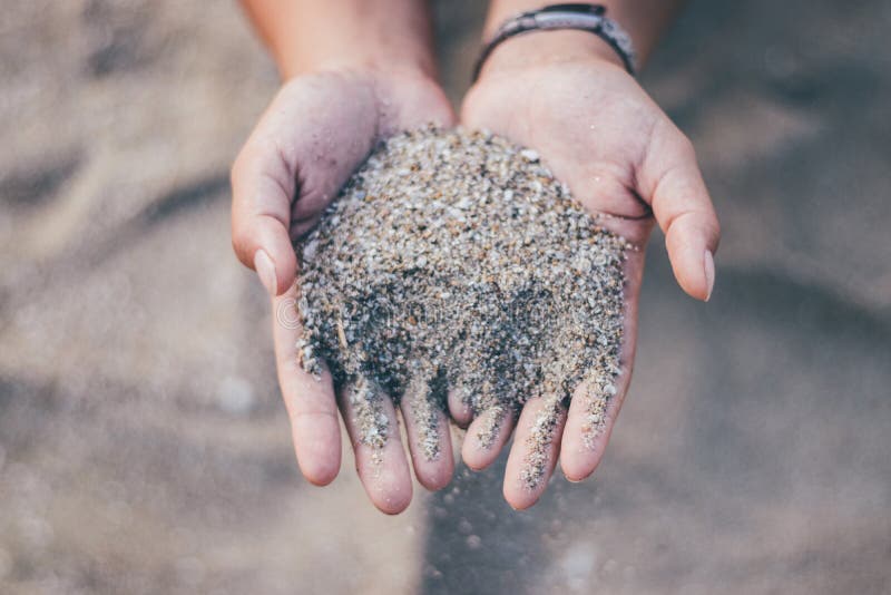 Sand on hand stock image. Image of holding, closeup - 145447363