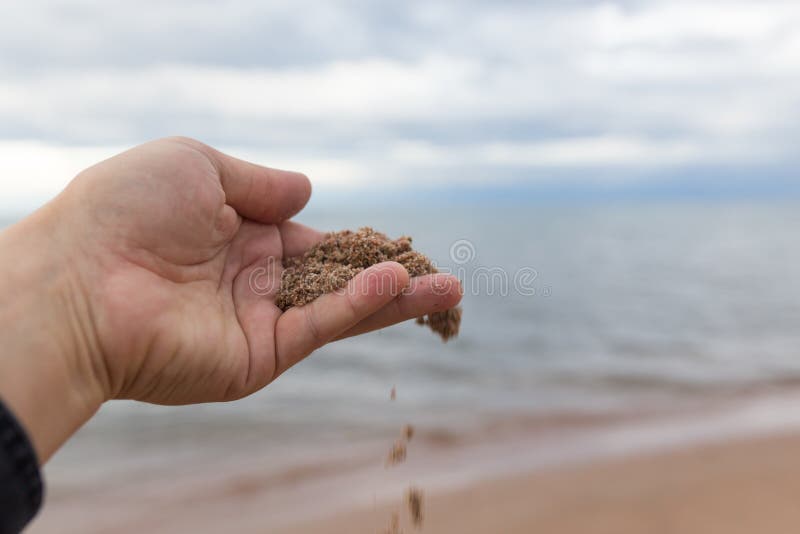 Sand in hand on the lake stock photo. Image of young - 111417946