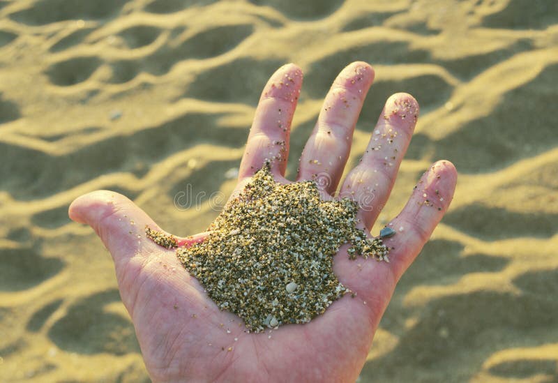 Sand in the hand stock photo. Image of outdoors, sandy - 104675794