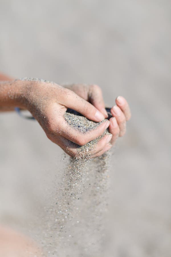 Sea sand on his hands stock photo. Image of clean, grain - 23830268