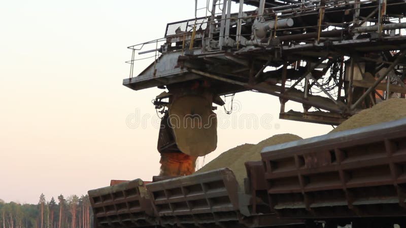 Mining Excavator Loading Sand in Dumper Truck at Sand Quarry. Excavator ...