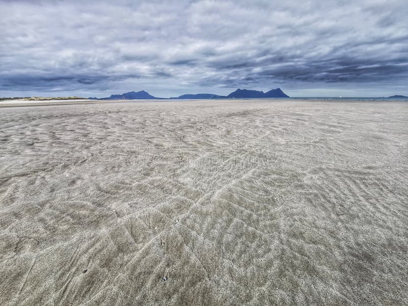 Sand Patterns on Sandy Ocean Beach Under Moody Cloudy Sky Stock Image ...