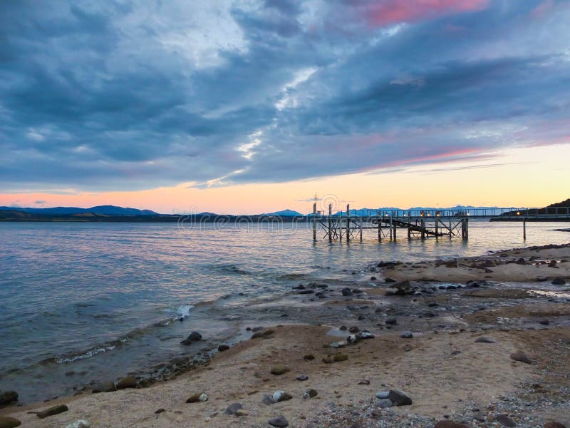 Sand rocky beach in sunset stock photo. Image of climate - 66232910