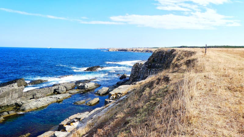 Sand and rocky coast stock image. Image of coast, waves - 104672613