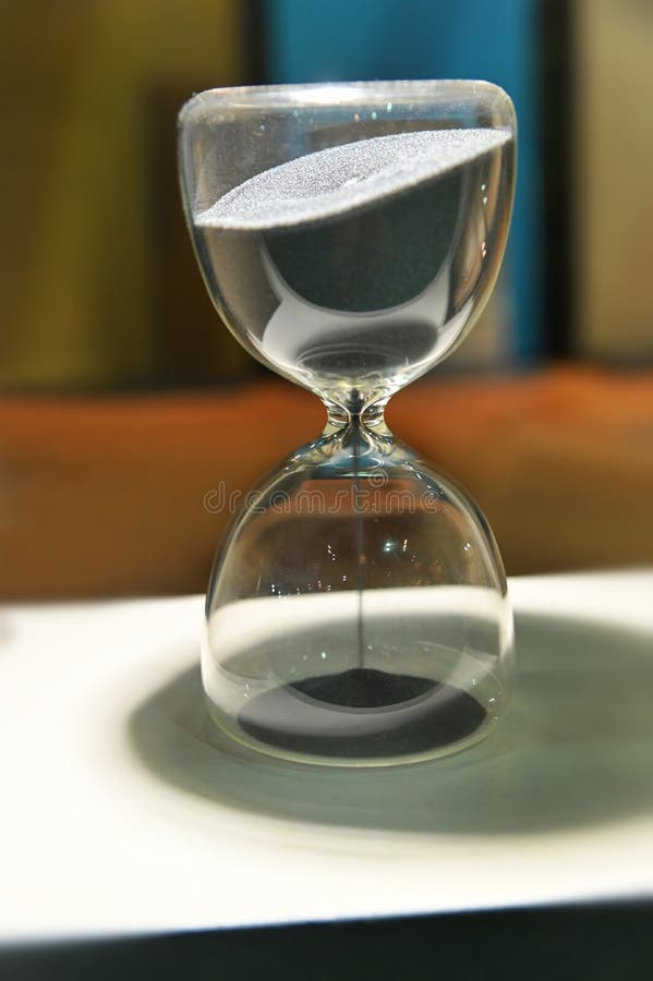 Sand Running through the Bulbs of an Hourglass that Measures the ...