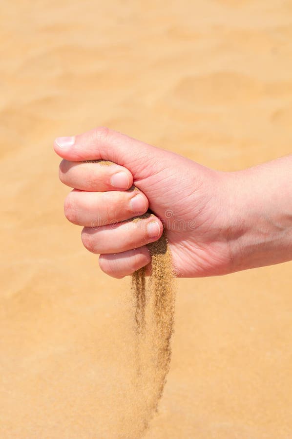 Sand running through hand stock photo. Image of time - 59309184