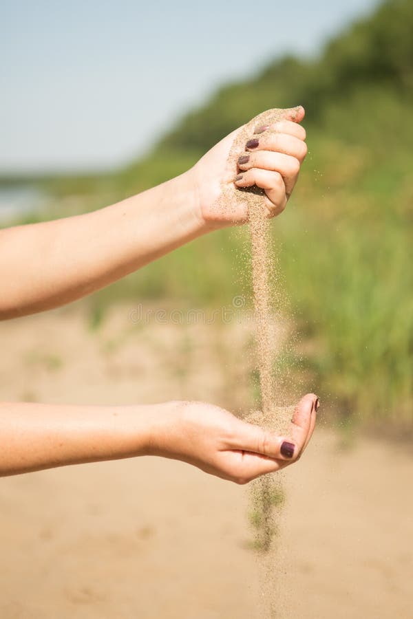 Sand Running through Hands of Woman Stock Photo - Image of hourglass ...