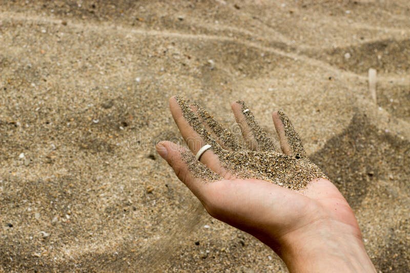 Sand Running Down from Man`s Hand at the Beach Stock Photo - Image of ...