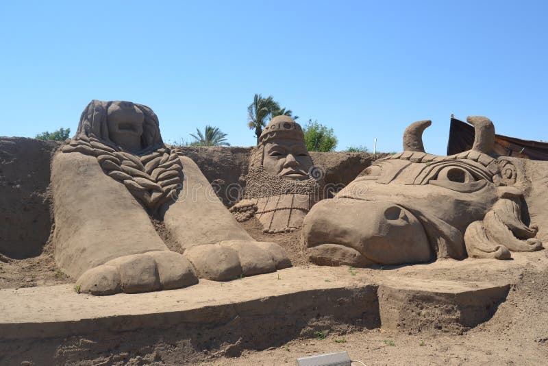 Sand Sculpture Depicting Humans, Ox and Lions Stock Image - Image of ...